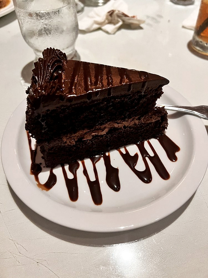 Chocolate cake that doesn't need deconstructing or reimagining – just three layers of unapologetic decadence that would make your cardiologist wince and your soul sing.