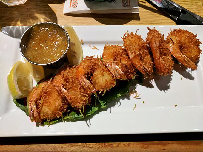 Golden coconut shrimp arrives like edible sunshine, each bite a tropical vacation for your taste buds.