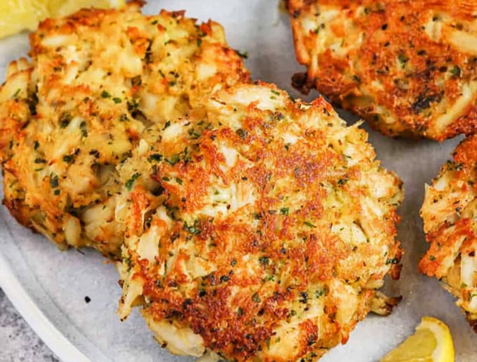 These golden-brown crab cakes aren't just fried, they're fulfilling a delicious destiny—crispy exterior giving way to tender, herb-flecked seafood treasure.