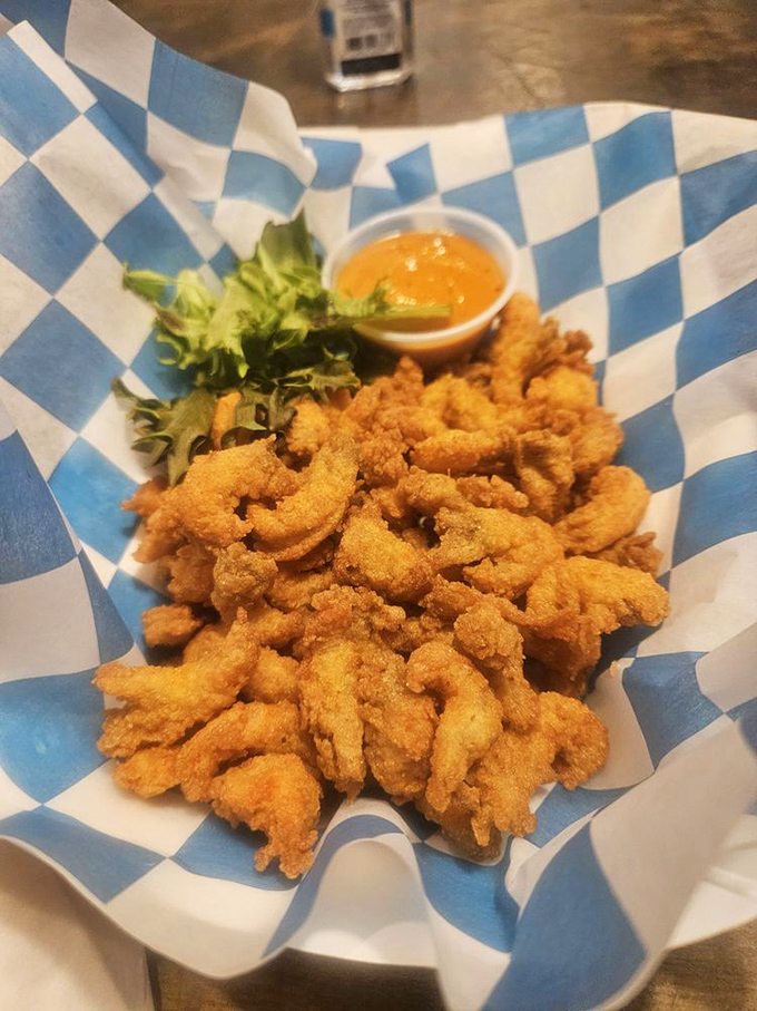 Golden-fried crawfish tails that crunch like nature's potato chips, served with a dipping sauce worth bottling and taking home.