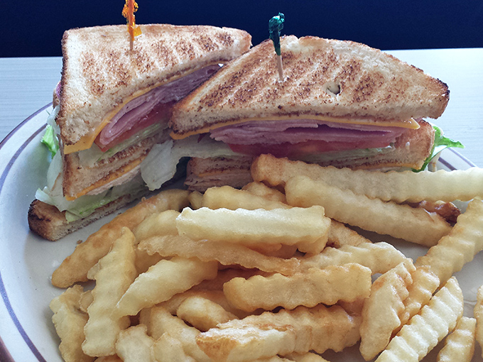 This club sandwich isn't playing around. Stacked higher than your weekend expectations, with crispy fries standing guard alongside.