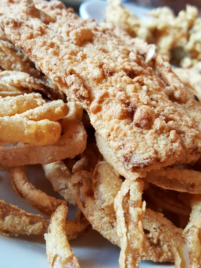 This isn't just fried fish—it's edible architecture. The perfect golden crust protecting tender white fish is engineering you can eat.
