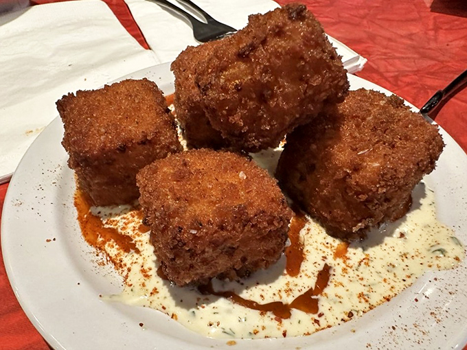 These aren't just fried mac and cheese squares—they're what would happen if comfort food went to finishing school and came back with a PhD in deliciousness.