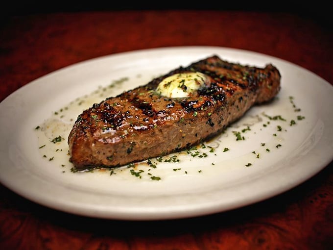 This steak, sporting those coveted crosshatch grill marks and topped with herb butter, isn't just dinner – it's edible performance art you created yourself.
