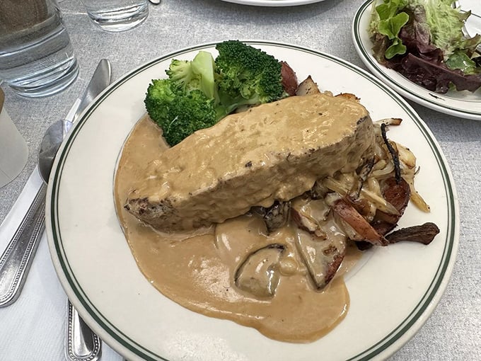 The meatloaf here doesn't just sit on the plate—it commands it, surrounded by a moat of mushroom gravy that you'll want to swim in.