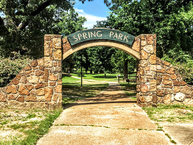 Spring Park's stone archway isn't just an entrance – it's a portal to simpler pleasures like picnics, people-watching, and actual face-to-face conversations.