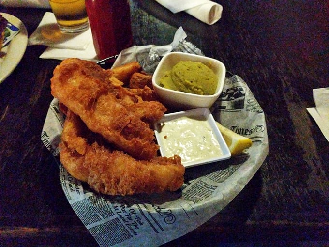 Newspaper-lined plates aren't just for show—they're tradition. Crispy fish, proper chips, and those distinctive mushy peas create the holy trinity of British pub fare.