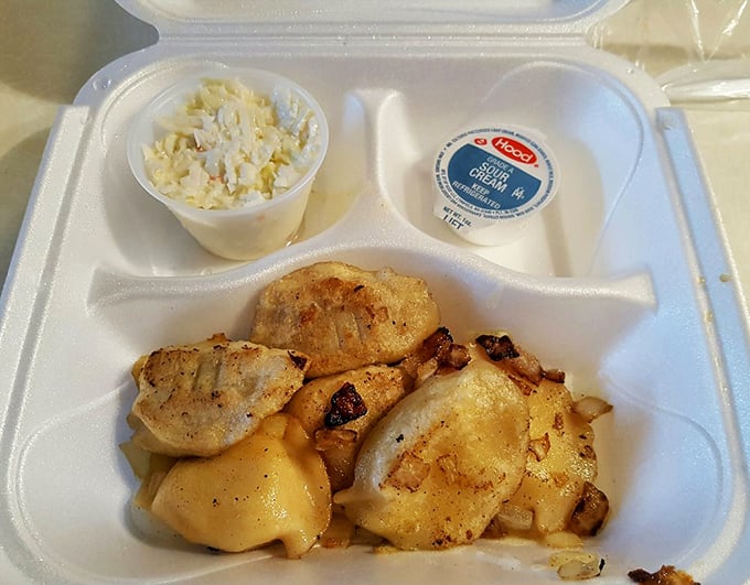 These pierogies aren't just served—they're presented like the royalty of Polish cuisine they are, complete with a sour cream crown.