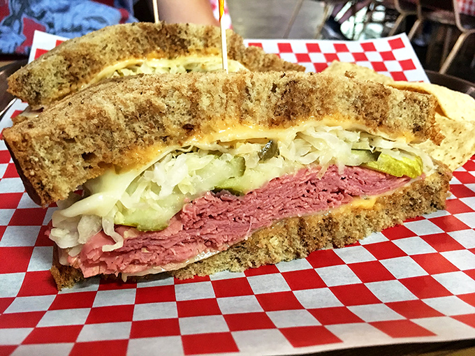Layer upon glorious layer – corned beef, sauerkraut, Swiss cheese, and Russian dressing create a sandwich architecture that would make Frank Lloyd Wright weep with joy.