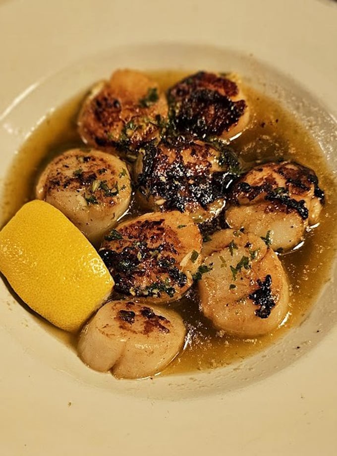 These seared scallops aren't just cooked—they're transformed into buttery ocean jewels swimming in a garlicky broth that begs to be sopped up.