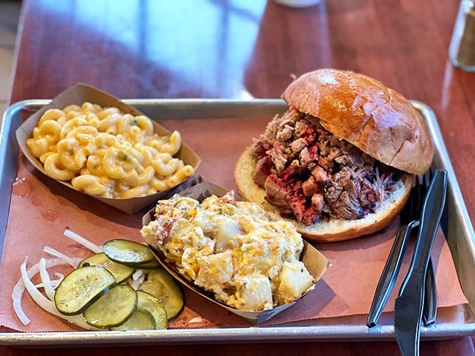 This sandwich plate showcases the holy trinity of BBQ perfection: tender meat, crusty exterior, and sides that don't just phone it in.