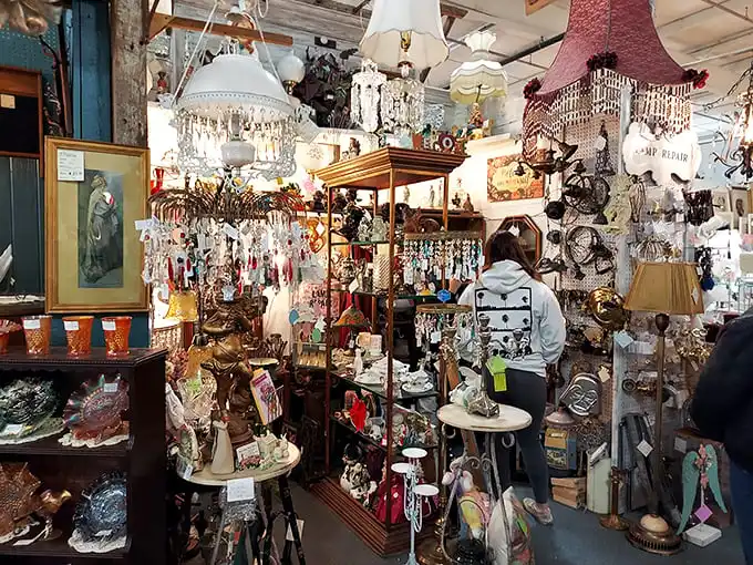 Chandeliers dangle like crystallized memories in this booth where shoppers hunt for that perfect piece of illuminated history. 