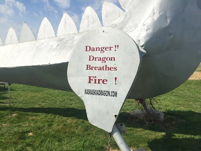 Fair warning: this isn't your average roadside photo op. The sign's straightforward message perfectly captures the dragon's no-nonsense Midwestern attitude.