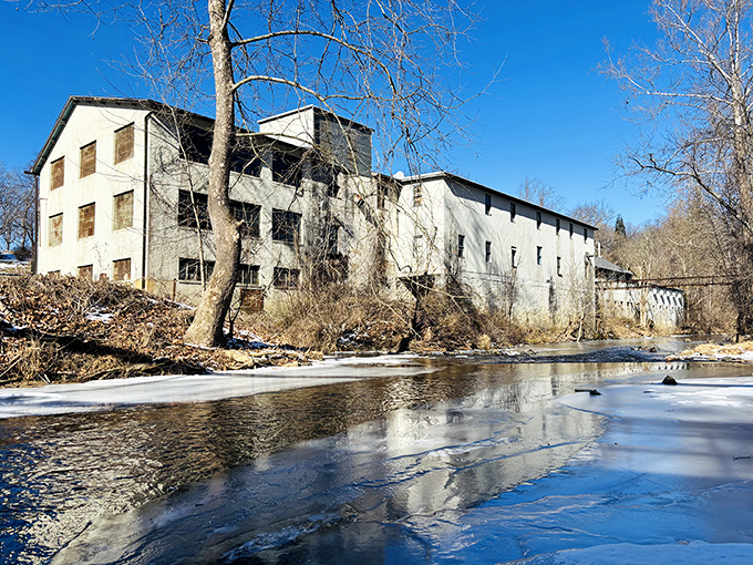 Historic mill buildings whisper stories of Delaware's industrial past while the creek provides soothing background music.