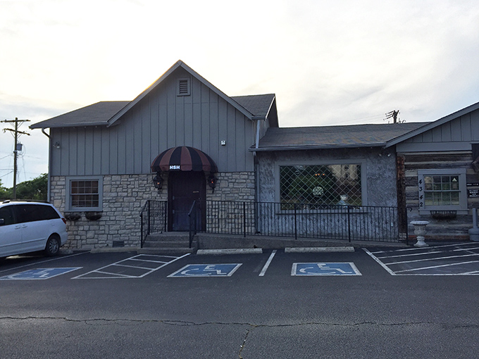 Don't let that modest stone exterior fool you – behind that striped awning lurks some serious steak mastery.