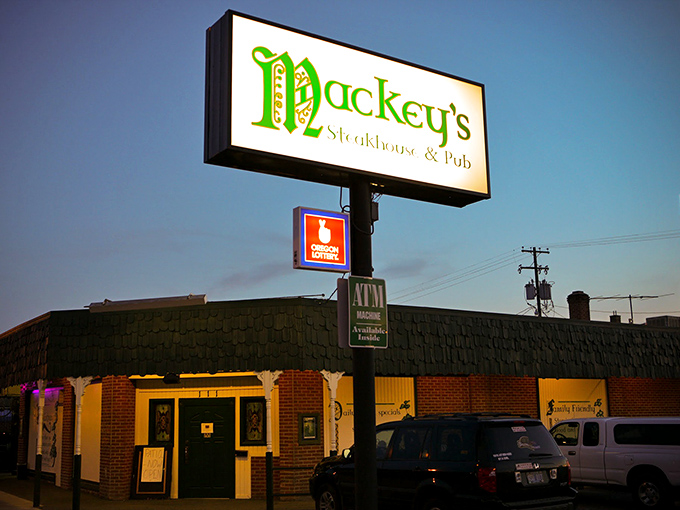 Mackey's glowing sign cuts through the evening sky, a beacon of hope for hungry travelers at Oregon's eastern edge.