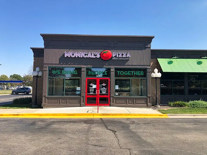 Monical's clean storefront might look modest, but that tomato logo signals thin-crust greatness lies within.