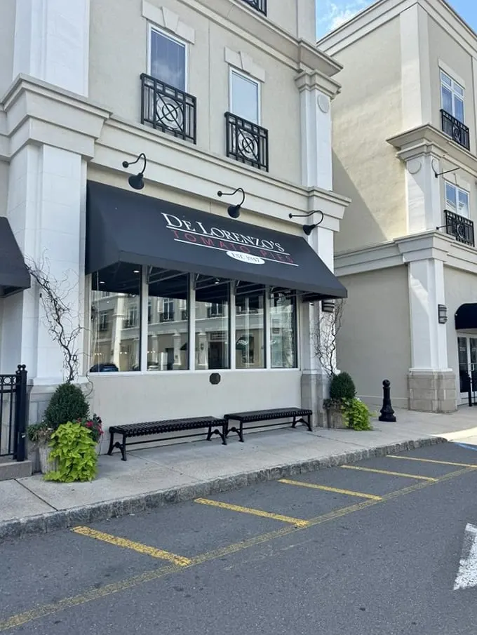 Those black benches outside De Lorenzo's aren't just for sitting – they're for recovering after a religious tomato pie experience.