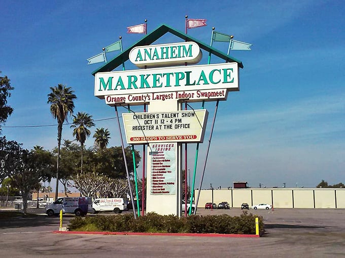 The retro signage stands like a mid-century modern lighthouse, guiding bargain hunters to "Orange County's Largest Indoor Swapmeet" with Palm Springs-worthy flair.