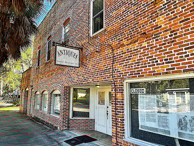 Brick walls and simple signage mark Micanopy's antique district, where treasures wait behind unassuming facades—like Florida itself, the magic is in the discovery.