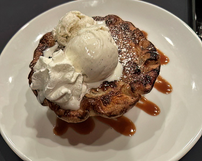 Not all heroes wear capes—some come as warm apple tarts crowned with ice cream and whipped cream, drizzled with caramel that glistens like liquid gold.