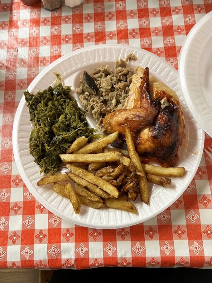 Barbecue chicken, collards, and fries – the holy trinity of Southern comfort that makes you want to loosen your belt before you even start.