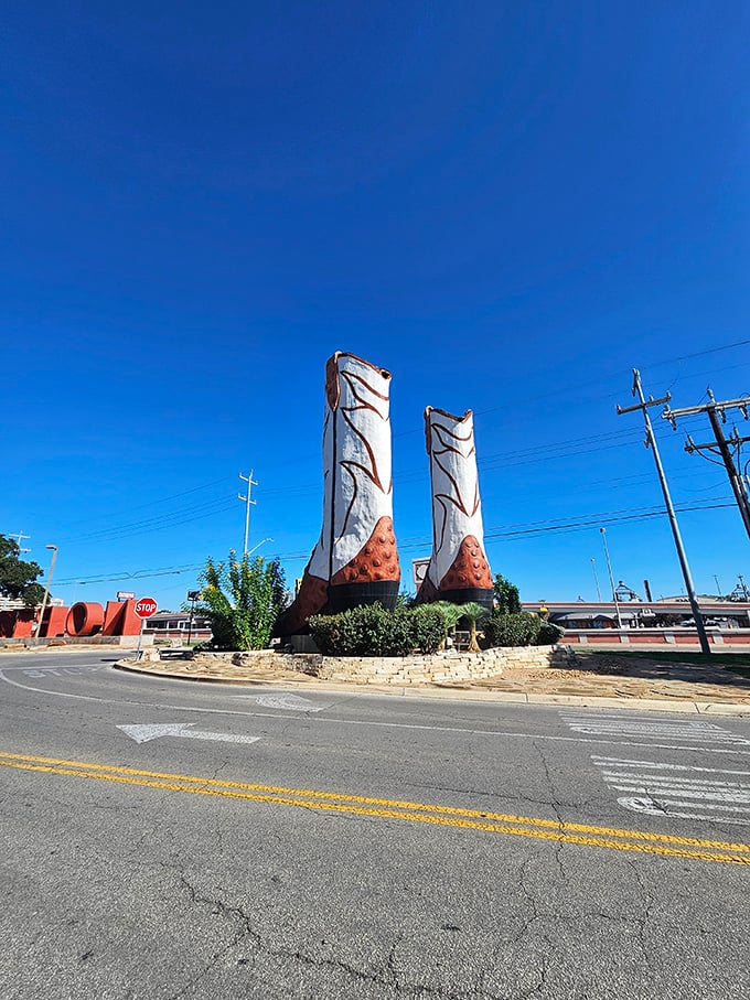 The boots create a striking silhouette against the San Antonio skyline, like sentinels guarding the entrance to shopping paradise.