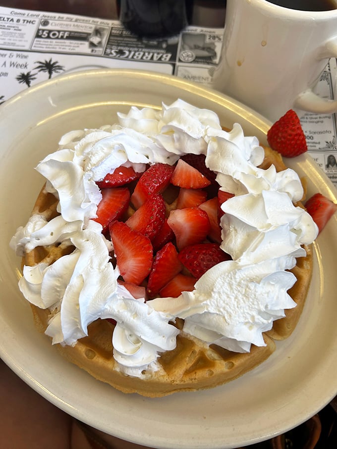 The star attraction in all its glory – a Belgian waffle crowned with fresh strawberries and whipped cream. Breakfast or dessert? The correct answer is "Yes."