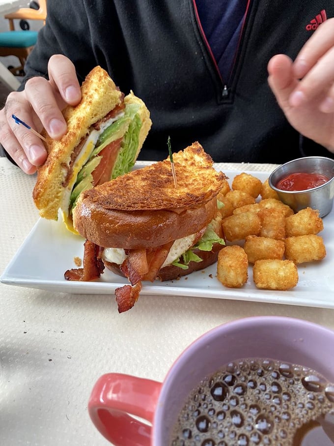 The breakfast sandwich that launched a thousand Instagram posts. Crispy bacon, fresh greens, and golden bread—with tater tots playing a delicious supporting role.