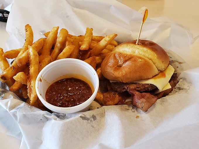 This isn't just a burger – it's an engineering marvel of beef, cheese, and toasted bun, with a side of BBQ sauce for good measure.