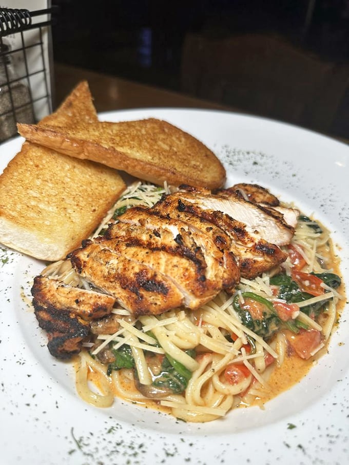Blackened chicken perched atop a swirl of pasta swimming in creamy sauce – comfort food that's dressed up for a night on the town.