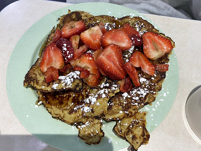 The California French Toast doesn't just elevate bread—it transforms it into a sweet island paradise topped with fresh strawberries and powdered sugar.