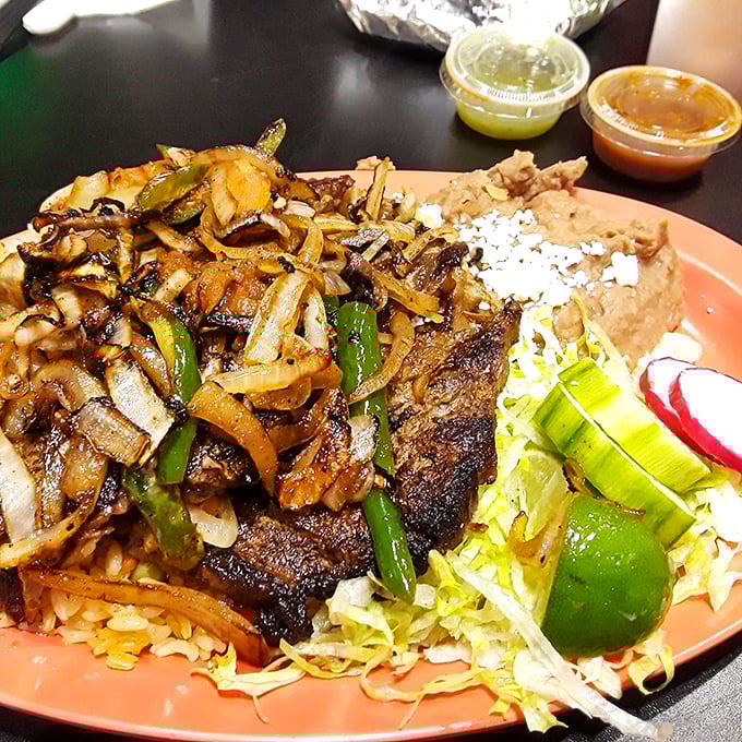 Carne asada that's been kissed by fire and blessed by spices, served with the respect it deserves alongside perfect rice and beans.