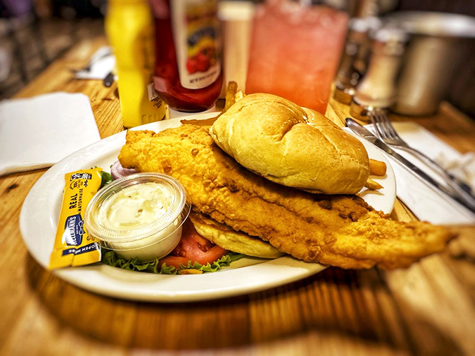 This catfish sandwich isn't just a meal—it's a Southern baptism between two pieces of bread, with tartar sauce providing the blessing.