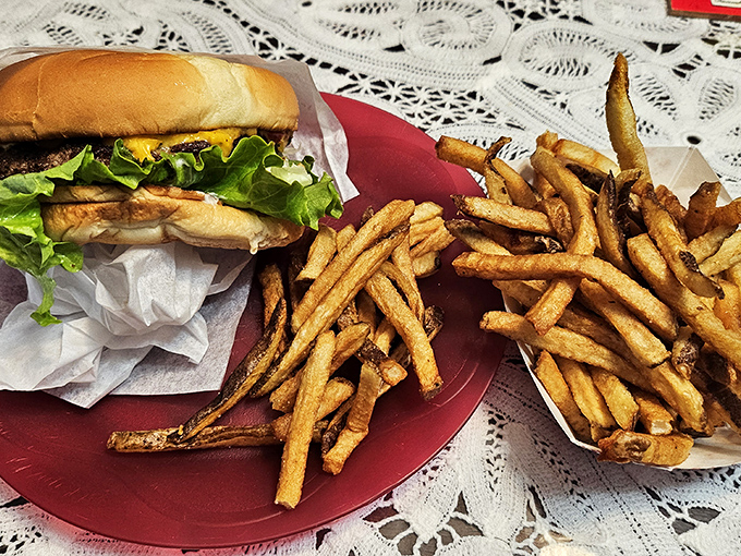 The classic American duo – a perfectly proportioned cheeseburger alongside those legendary fries. This plate doesn't need white tablecloths to qualify as fine dining.