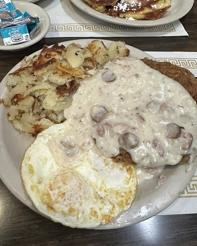 Chicken fried steak smothered in creamy country gravy – the kind of hearty breakfast that fueled generations before "brunch" became a verb.