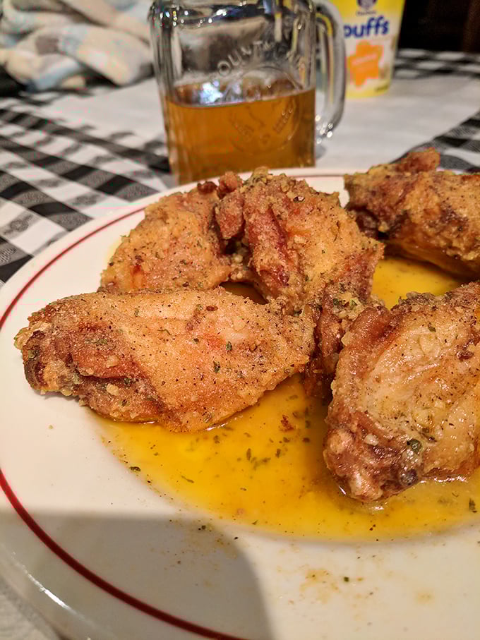 These aren't just chicken wings – they're crispy, golden-brown tickets to flavor town, glistening with buttery goodness that demands a cold beer companion.
