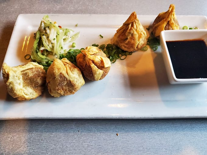 These aren't your average dumplings – they're little flavor bombs wrapped in delicate packages, like getting four perfect bites of happiness on one plate.