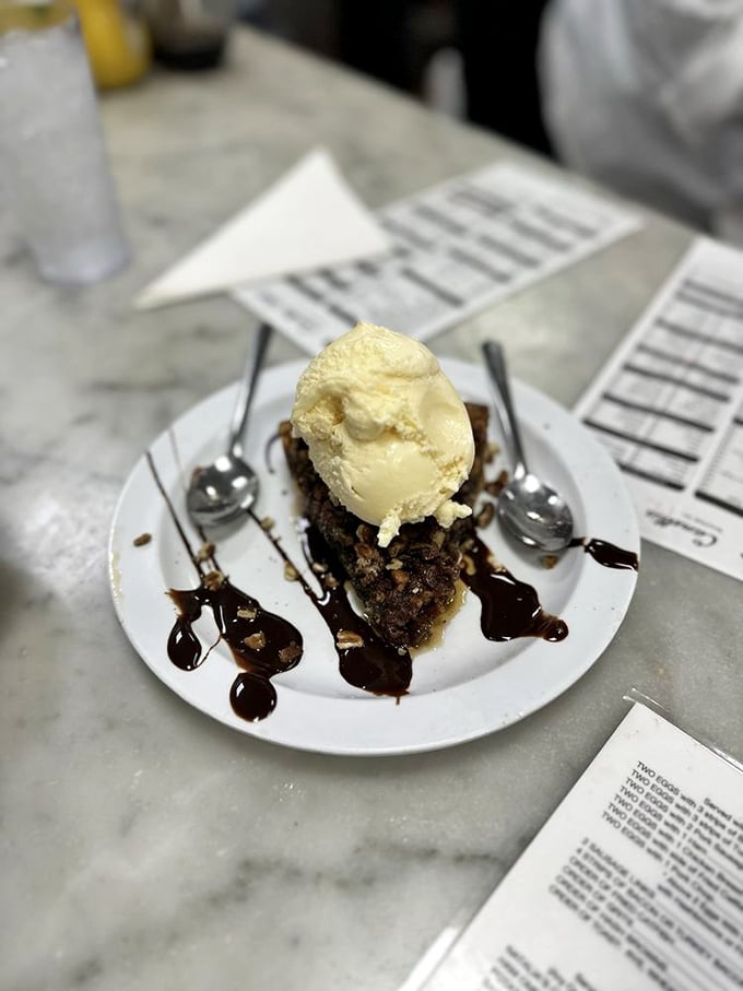 Pecan pie that makes grown adults weep with joy—the melting ice cream creating a sweet river delta on the plate.