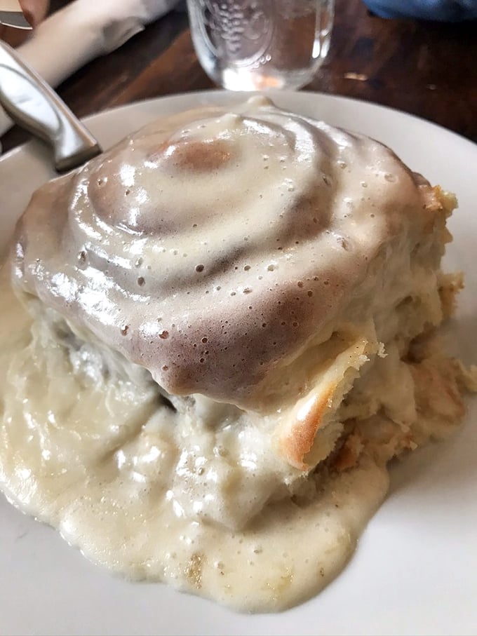 This isn't just a cinnamon roll; it's a gravity-defying monument to the art of breakfast indulgence. Resistance is futile, napkins are mandatory.