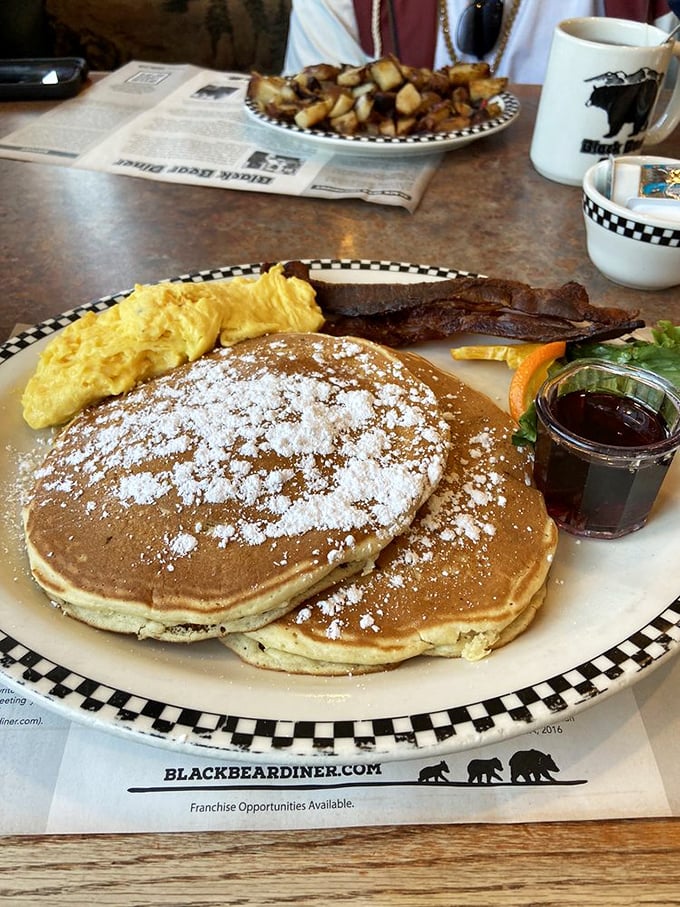 These aren't just pancakes—they're fluffy discs of breakfast perfection, dusted with powdered sugar and served with a side of morning happiness.