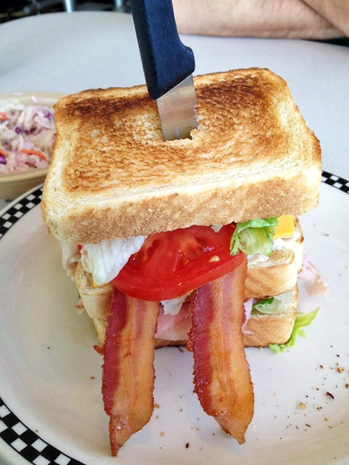 This club sandwich isn't playing around – perfectly toasted bread standing at attention while bacon salutes your good taste decisions.