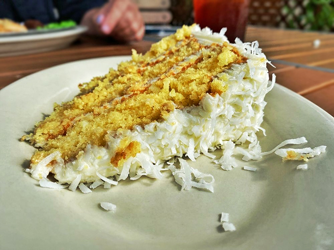 Layer upon heavenly layer of coconut bliss. This slice doesn't just satisfy your sweet tooth—it makes your sweet tooth write thank-you notes.