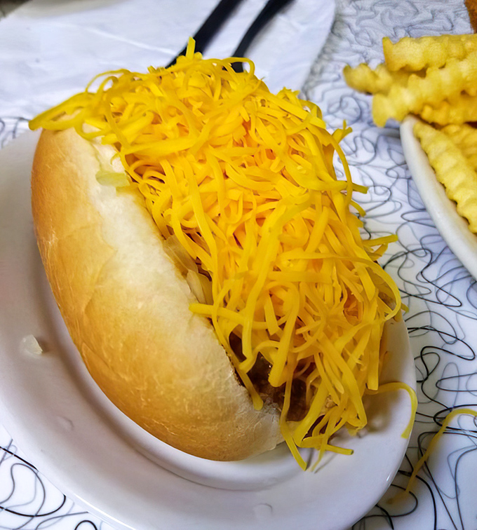 The cheese coney—where a hot dog disappears under an avalanche of neon-orange cheddar. It's not subtle, but neither are life's greatest pleasures.