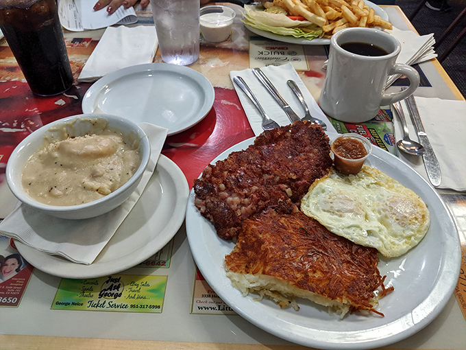 Behold the holy trinity of breakfast – crispy corned beef hash, eggs with yolks like liquid sunshine, and hash browns that crackle with each forkful.