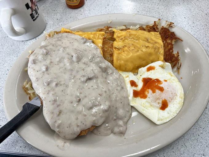 Country fried steak swimming in peppery gravy – the kind of breakfast that makes you want to take a nap and then come back for lunch.