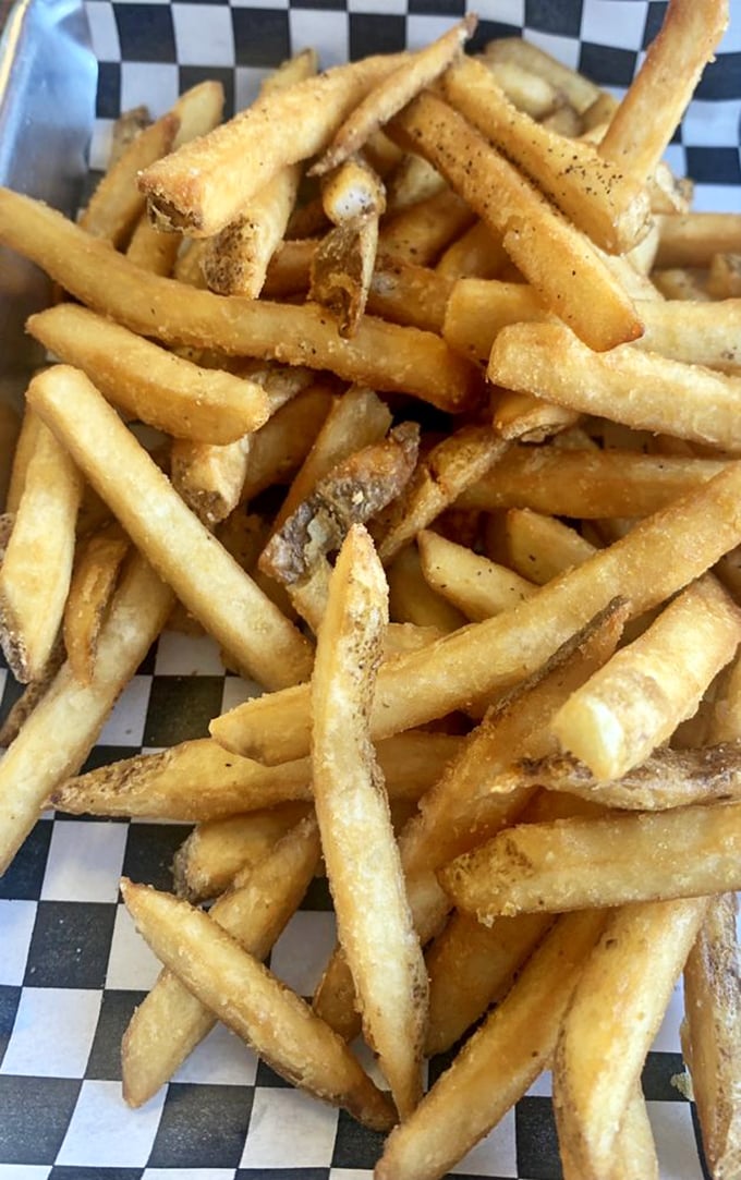 These aren't just fries; they're potato architecture—crispy exteriors protecting fluffy interiors like edible treasure chests. 