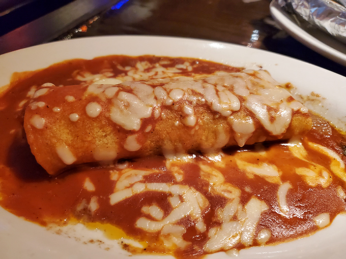 Sauce-drenched and cheese-crowned, this burrito doesn't just satisfy hunger – it negotiates peace treaties with your taste buds.