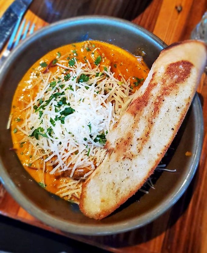 This isn't just soup; it's a sunset in a bowl. The Drunken Angel comes with a side of grilled bread perfect for sopping up liquid gold.