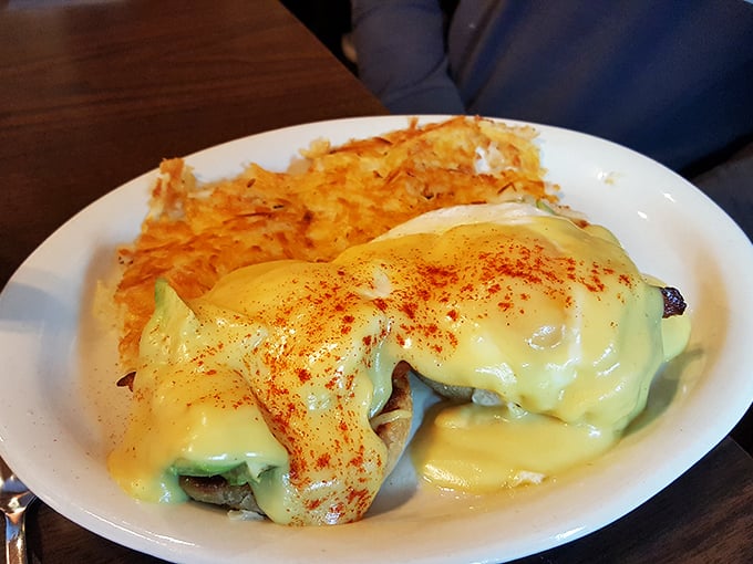 Architecture of breakfast perfection—English muffin foundation, protein middle layer, poached egg dome, all baptized in that sunshine-yellow hollandaise. Michelangelo would approve.